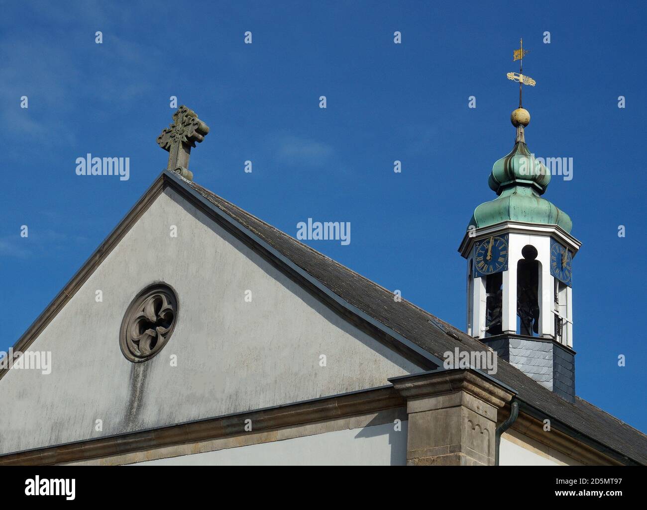The clock strikes 12! Old white church with cross and tower with gold ...