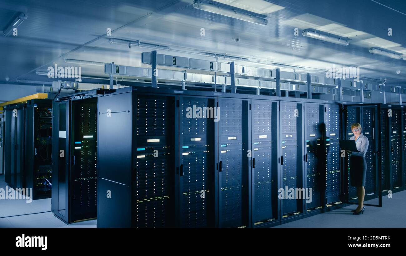In Data Center: Female IT Technician Stands before Open Server Rack ...