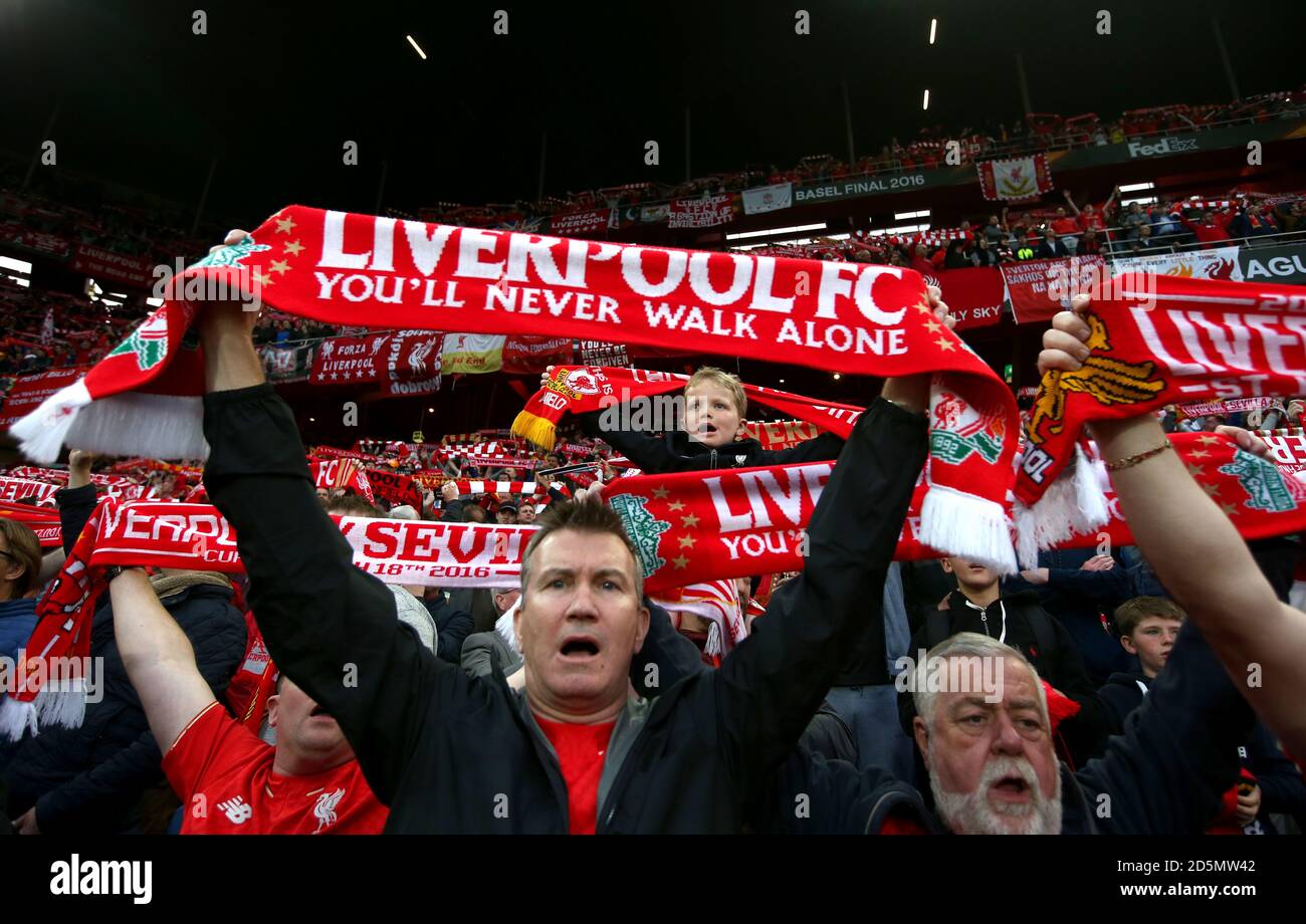 Liverpool fans cheer on their side in the stands Stock Photo - Alamy