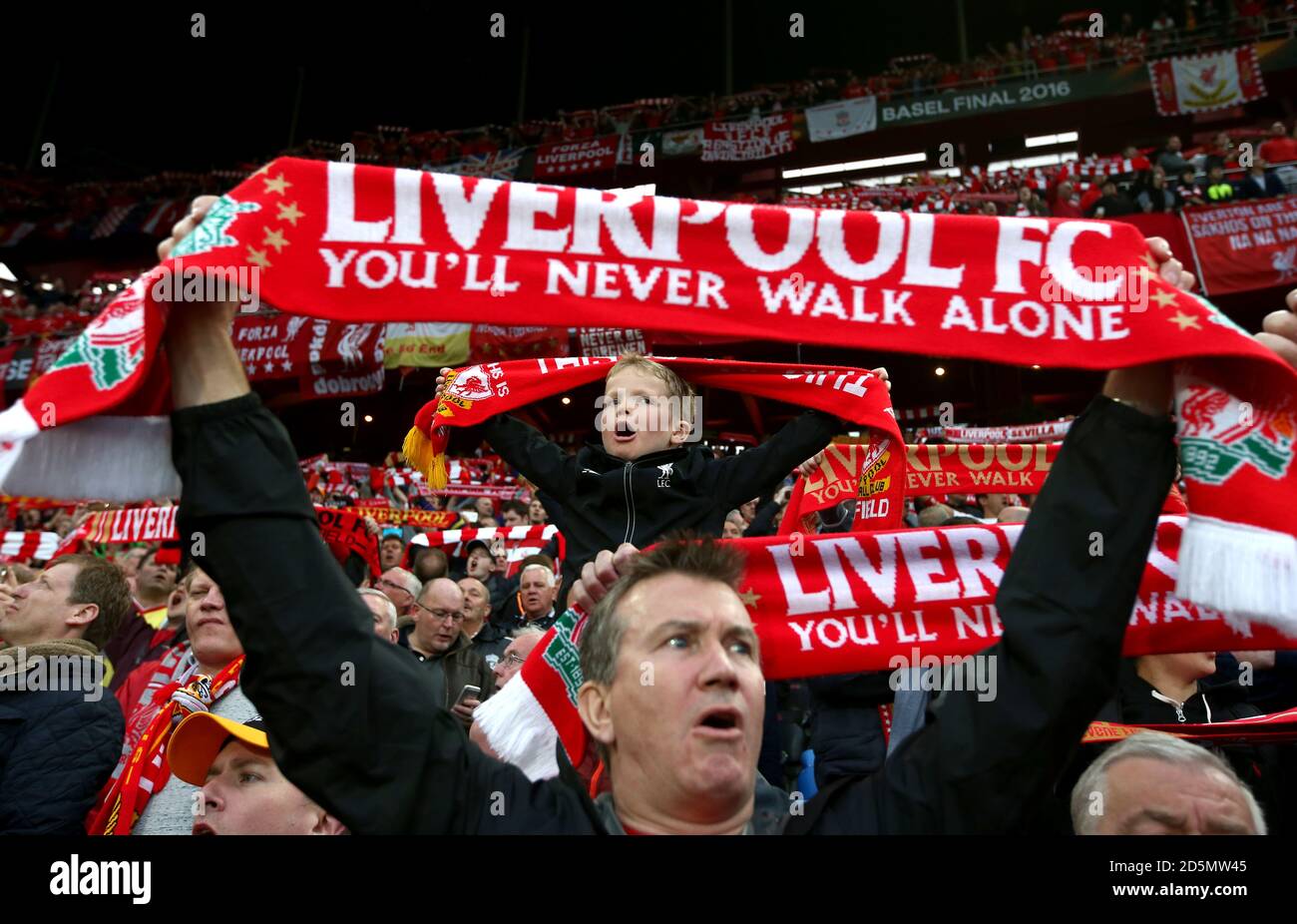 Liverpool fans cheer on their side in the stands hi-res stock ...