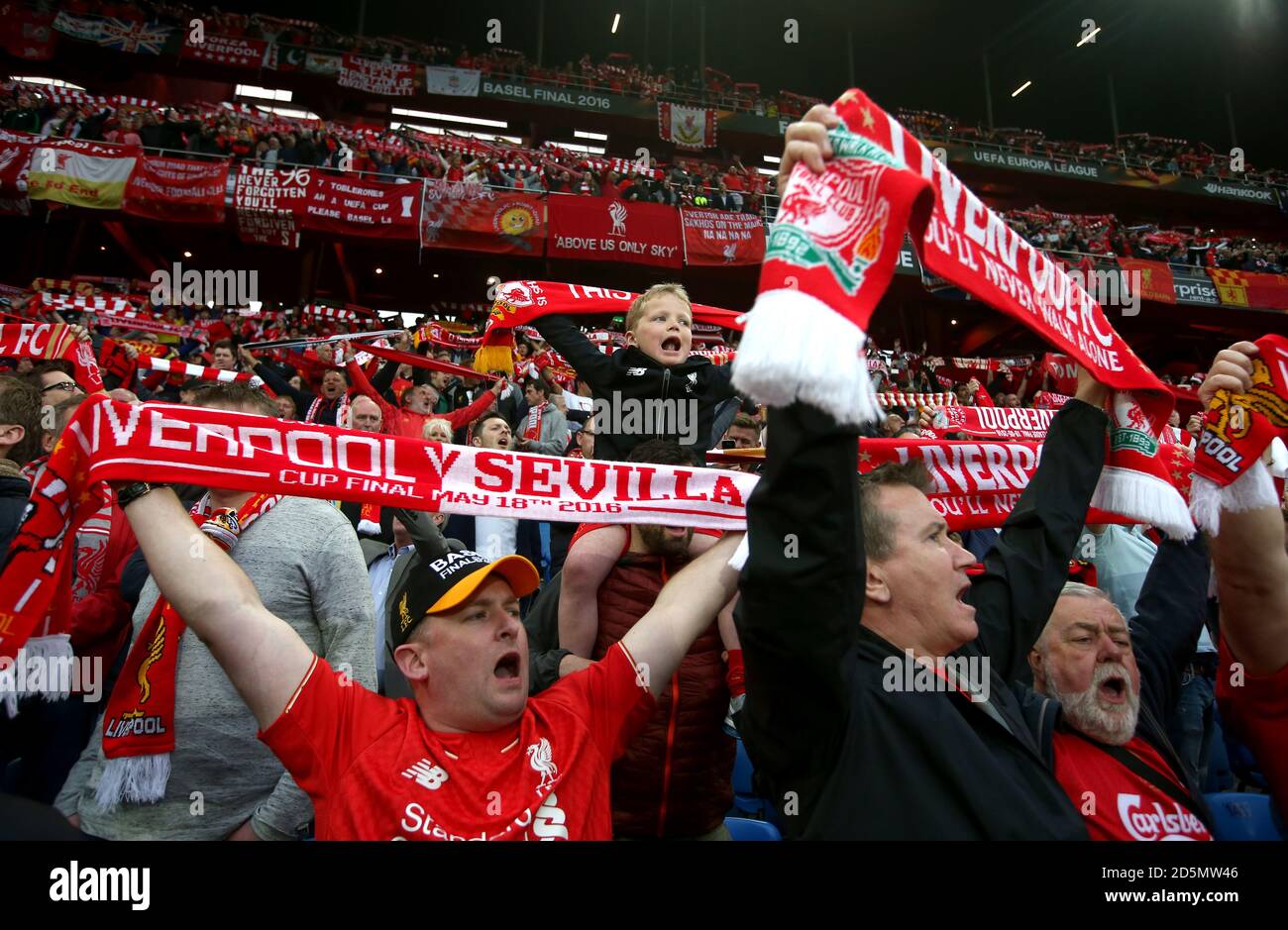Liverpool fans cheer on their side in the stands hi-res stock ...