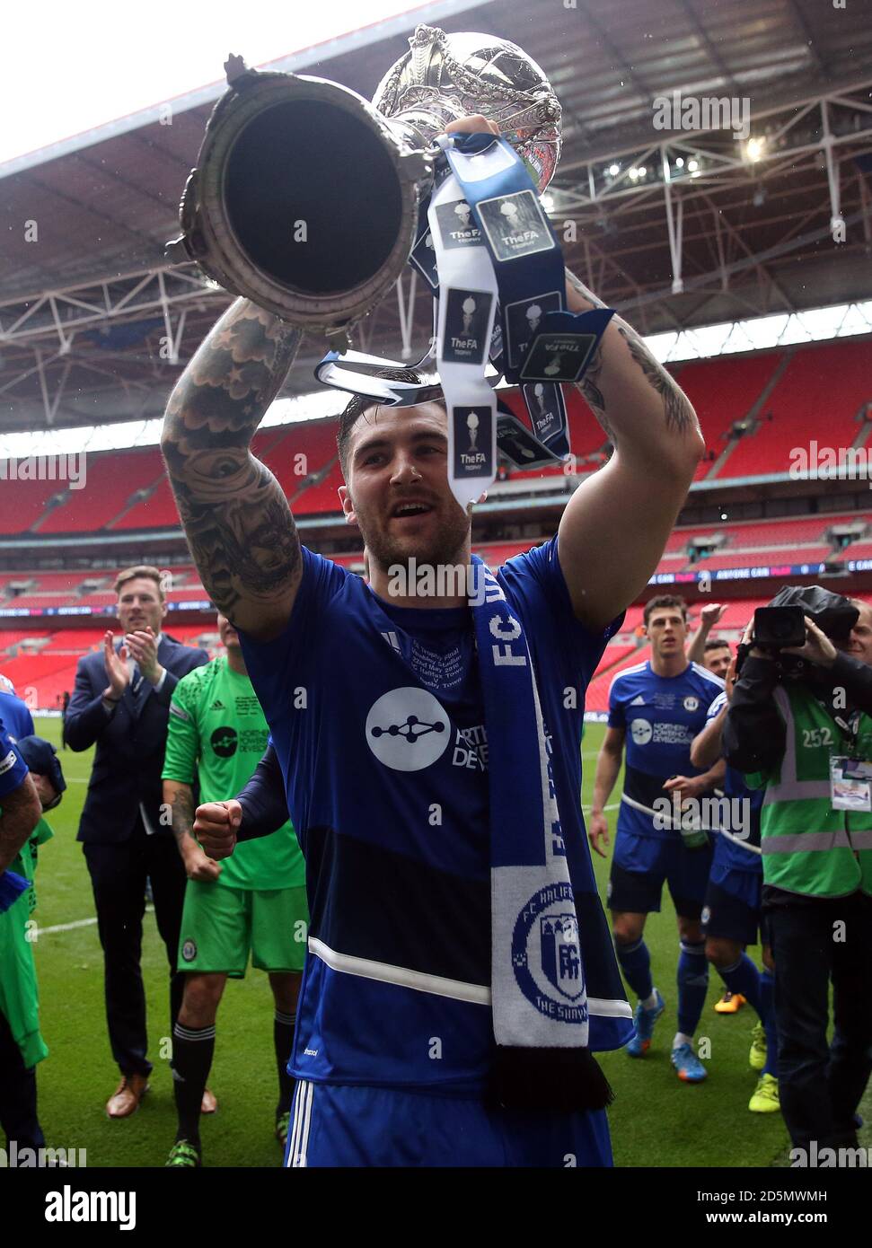 Halifax Town's Matty Brown lifts the trophy after the game Stock Photo - Alamy