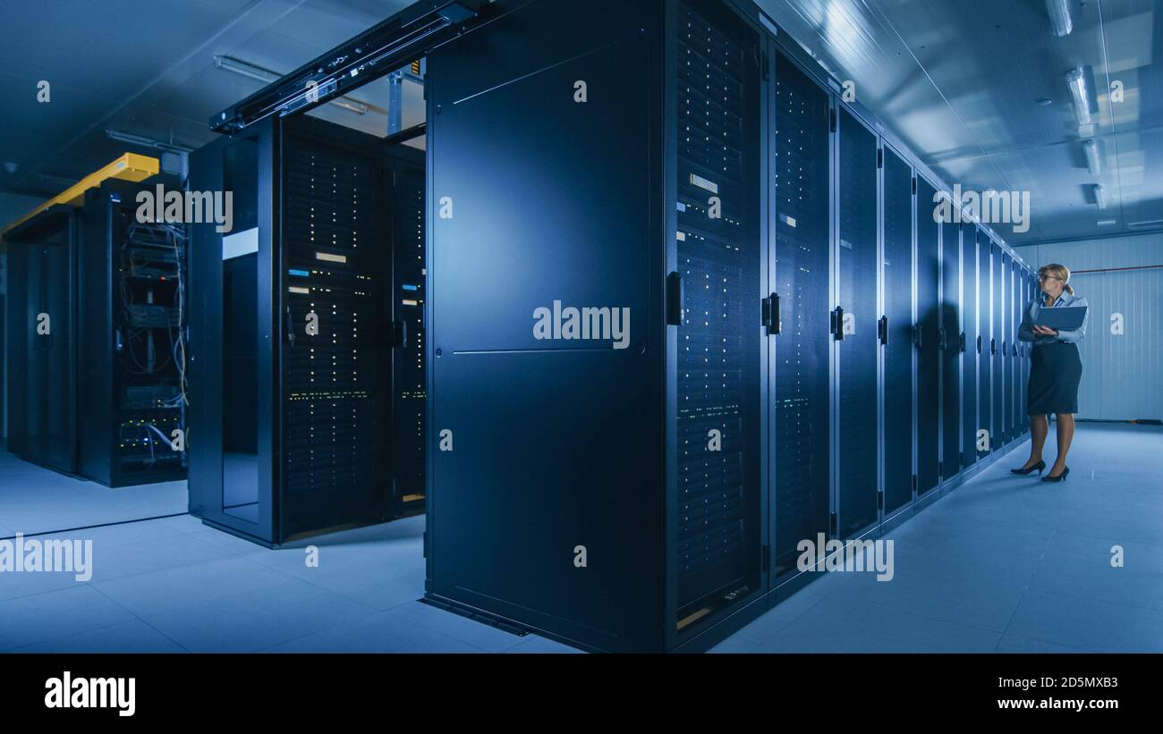 In Data Center: Female IT Technician Running Maintenance Programme on a ...