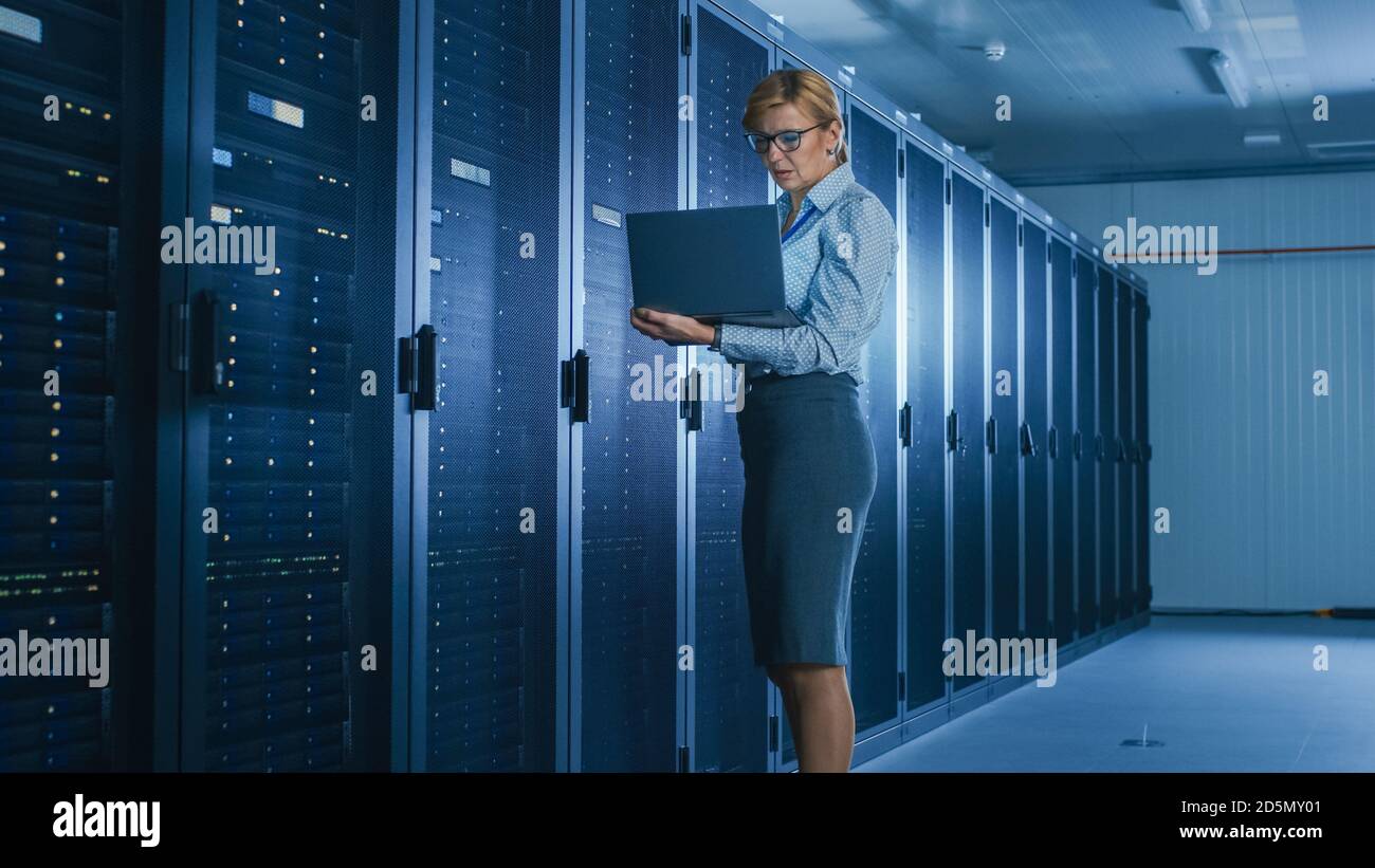 In Data Center: Female IT Technician Running Maintenance Programme on a ...