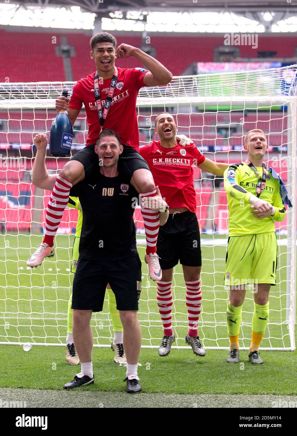 Barnsley's Ashley Fletcher celebrates on the shoulders of Head of ...