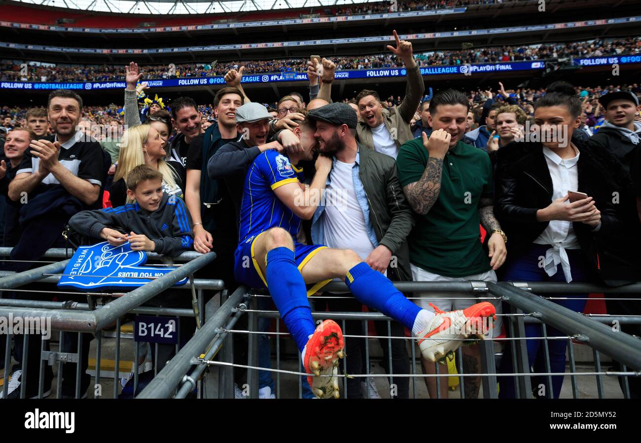AFC Wimbledon's Jake Reeves celebrates with fans in the stand after the ...