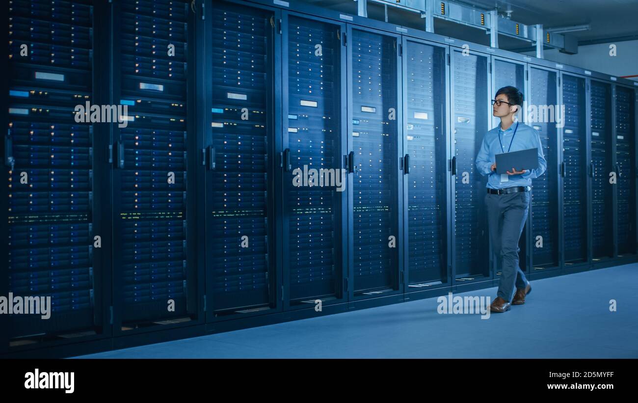 In Data Center: Male IT Technician Running Maintenance Programme on a ...
