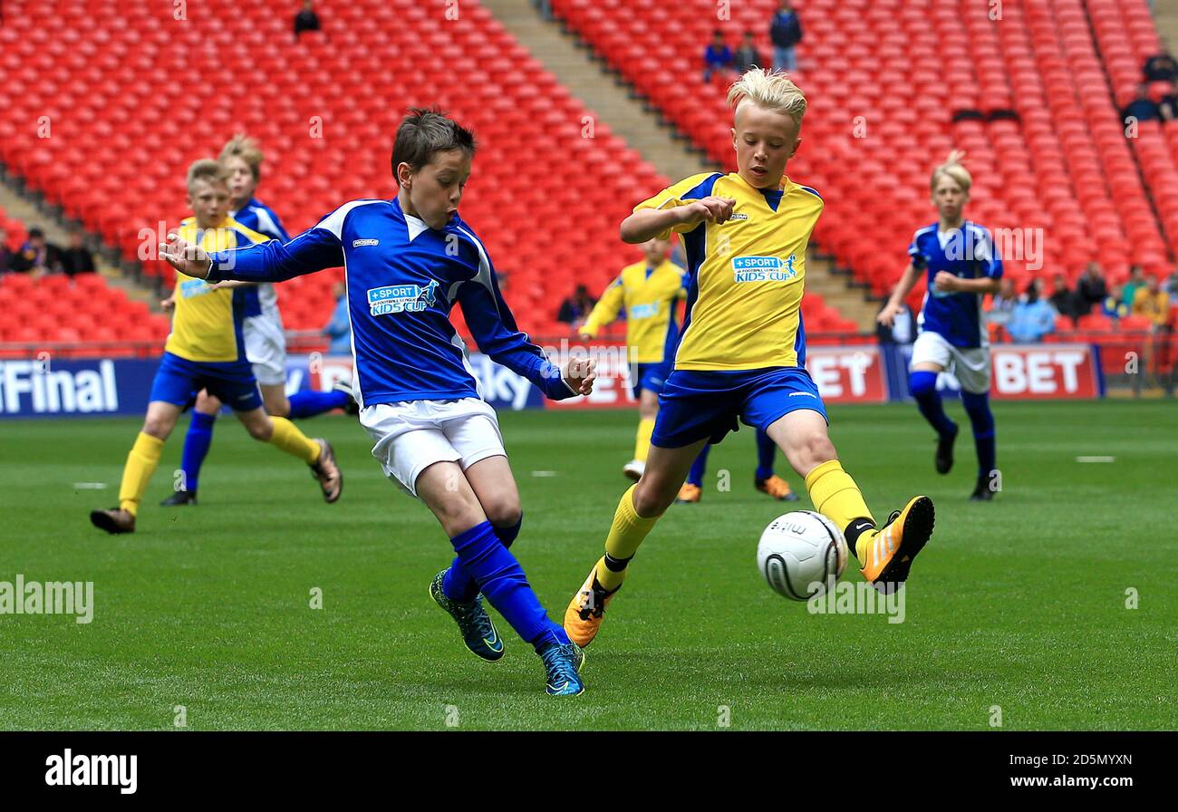 Kids compete in the + Sport Football League Kids Cup Final Stock Photo ...