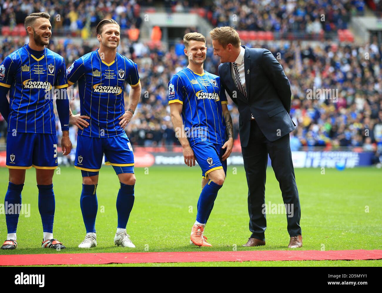 AFC Wimbledon manager Neal Ardley speaks with Jake Reeves before the ...
