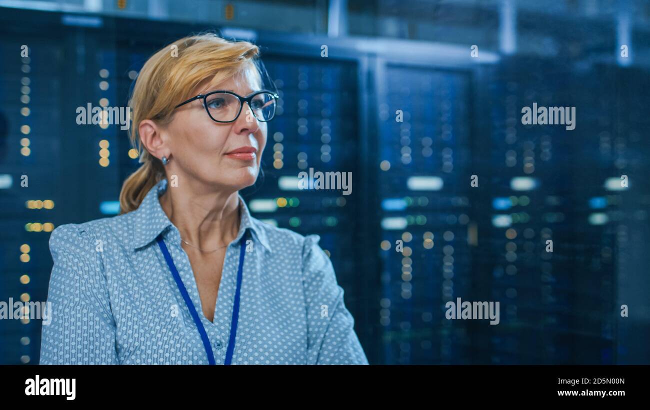 Portrait of a Beautiful Senior Female IT Technician Standing In Modern ...