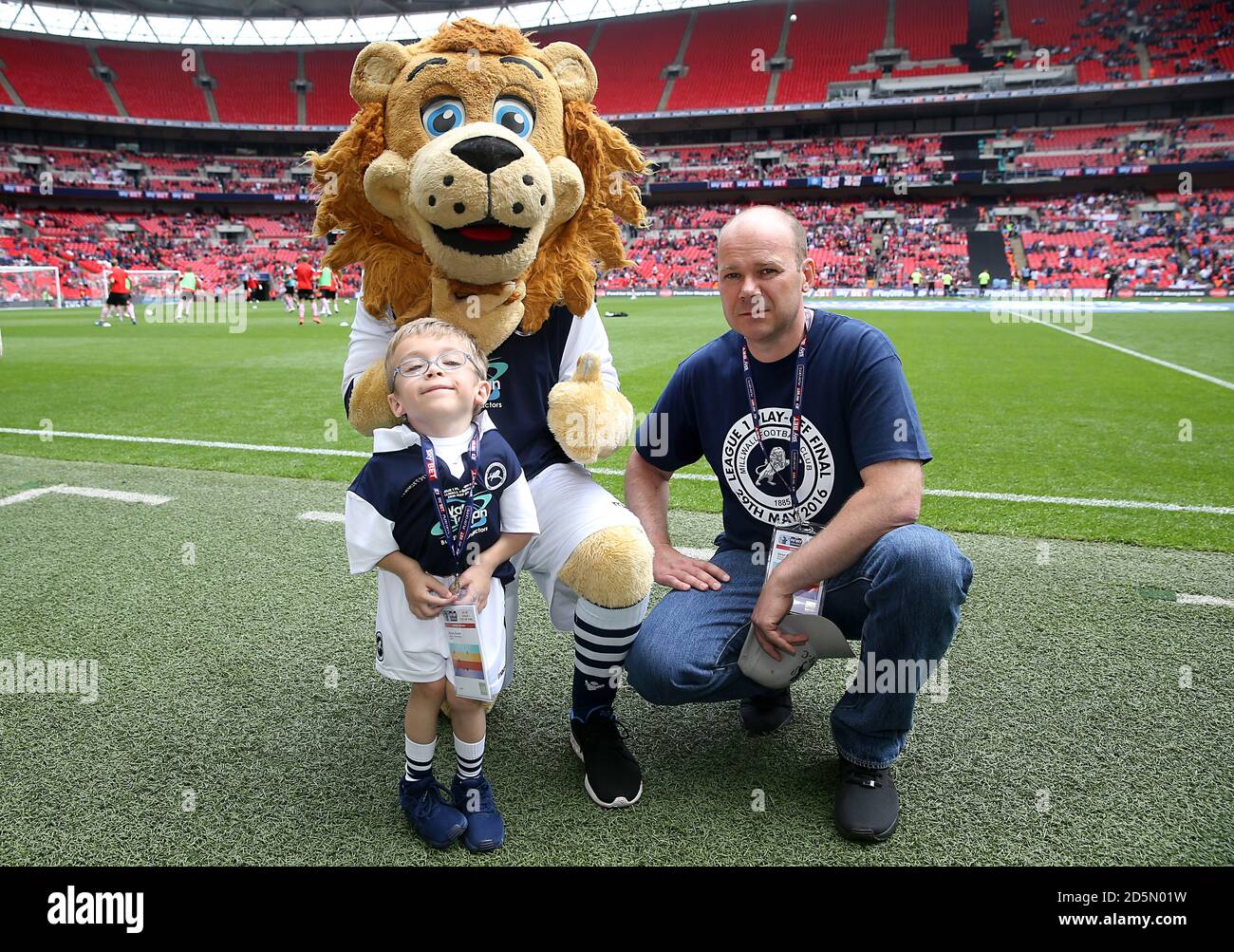 A yound mascot with Millwall mascot Zampa the Lion Stock Photo - Alamy