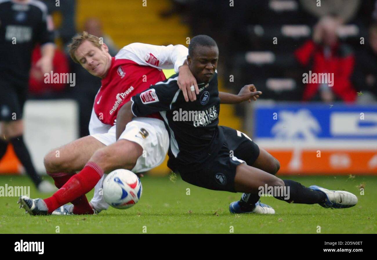 Rotherham's Martin Butler and Swansea's Marcus bean battle for the ball ...