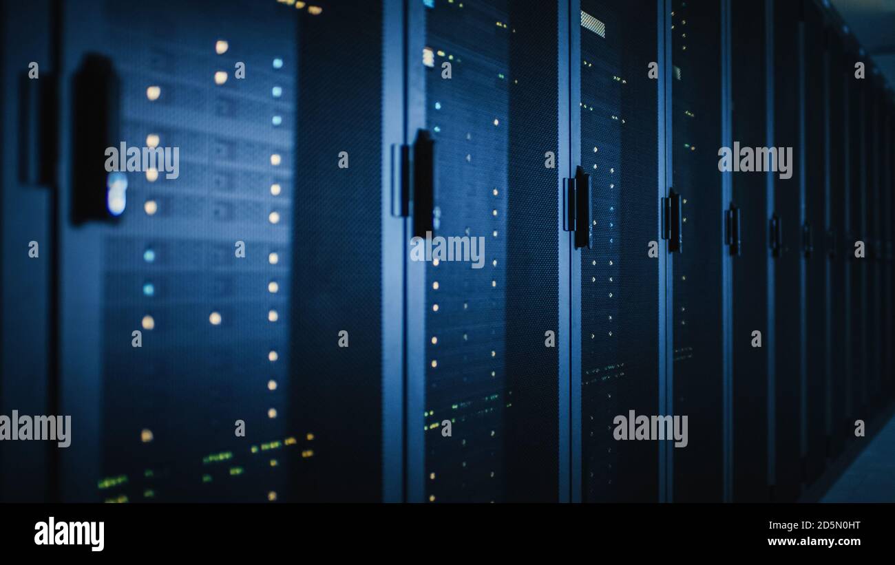 Shot of Dark Modern Data Center With Row of Fully Operational Server ...