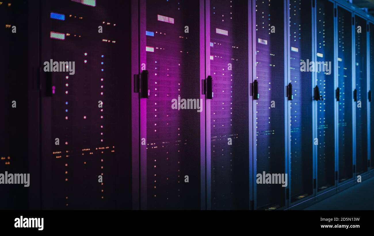 Shot of Dark Data Center With Multiple Rows of Fully Operational Server Racks. Modern ...