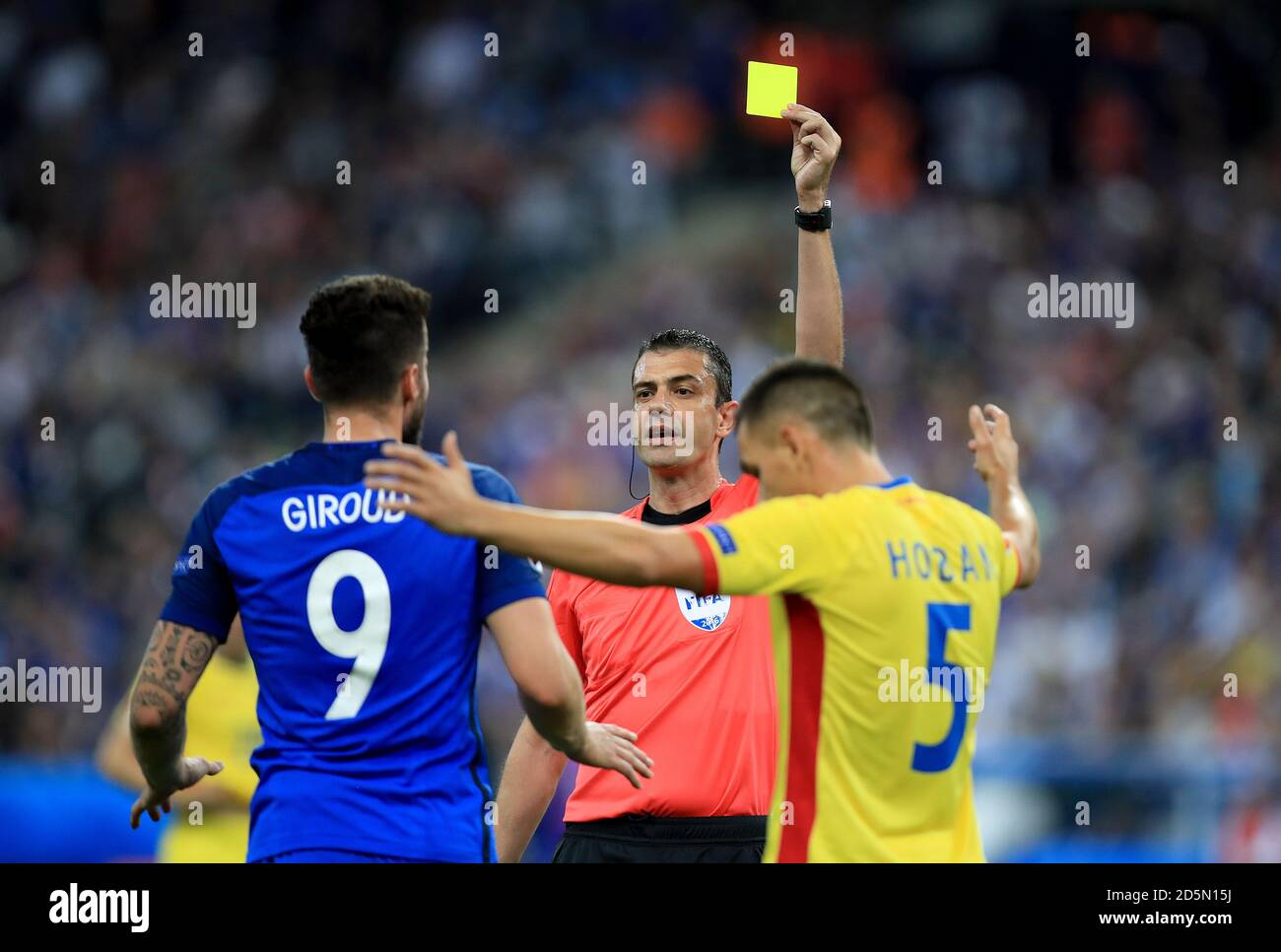 Match referee Viktor Kassai (centre) books France's Olivier Giroud ...