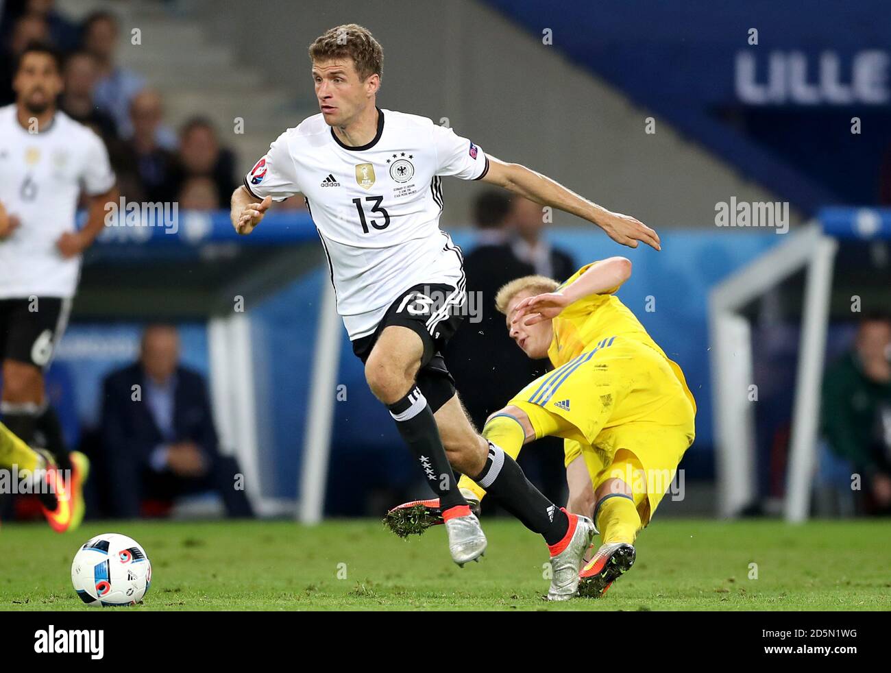Germany's Thomas Muller and Ukraine's Viktor Kovalenko (right) battle ...