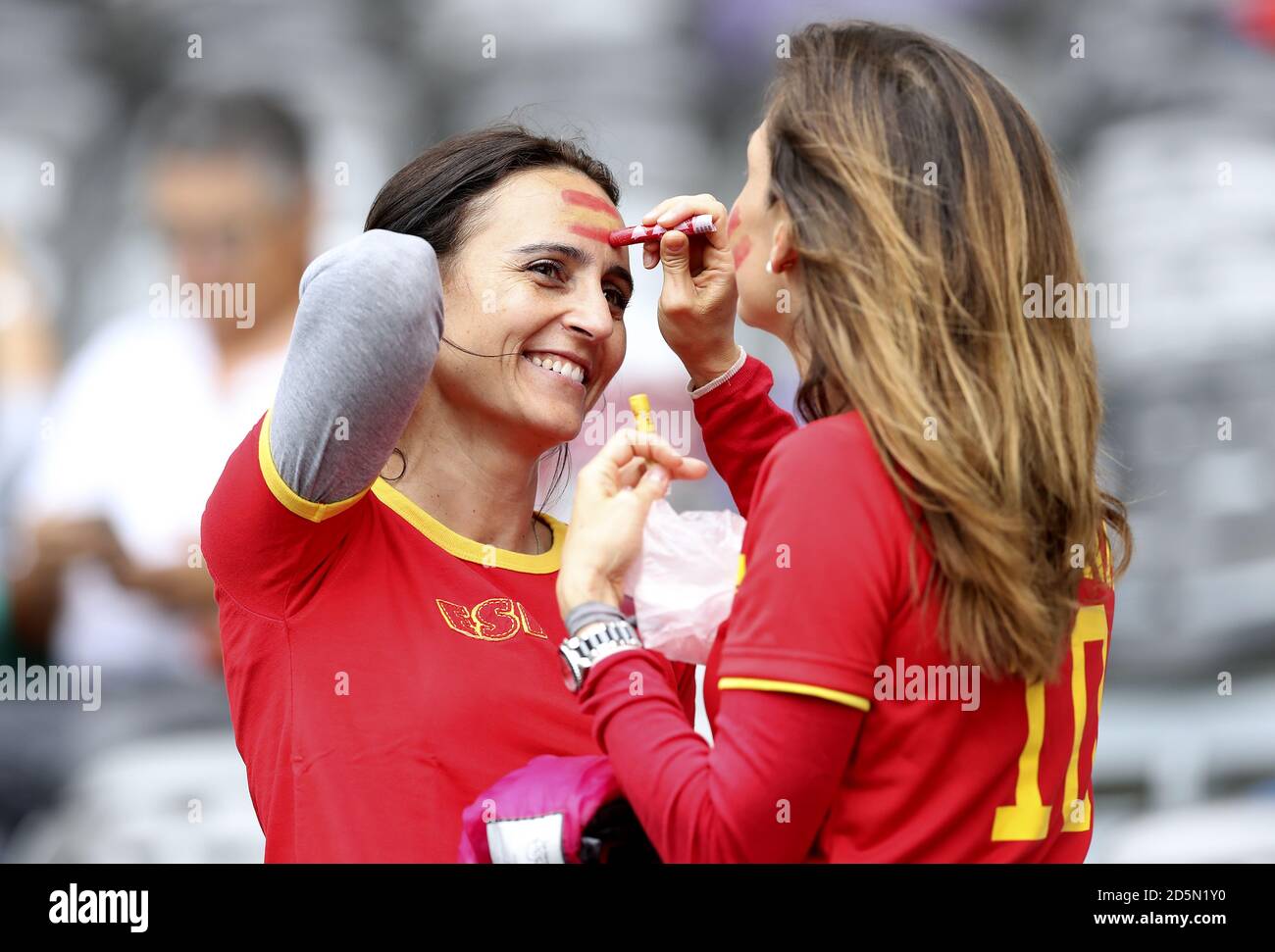 Spain fans apply face paint in the stands at the Stadium de Toulouse ...
