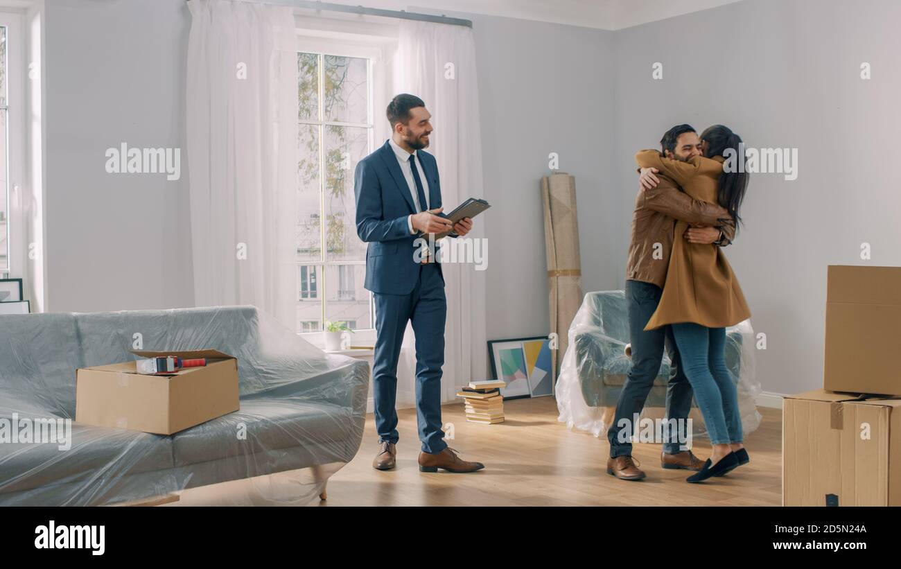 Real Estate Agent Shows Bright New Apartment to a Young Couple ...