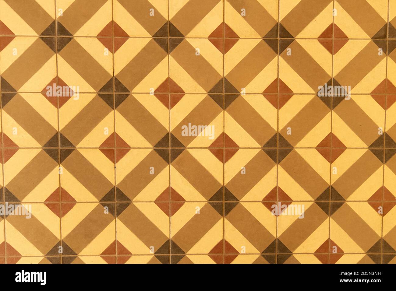 A geometric pattern of vintage floor tiles in yellow and brown Stock ...