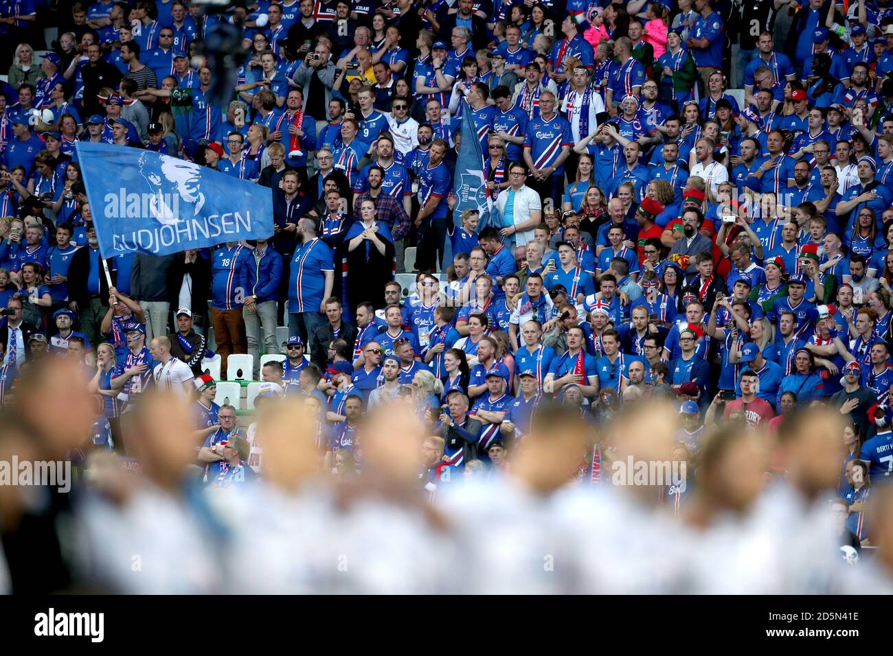 Iceland fans hold a flag in the stands in support of Eidur Gudjohnsen ...