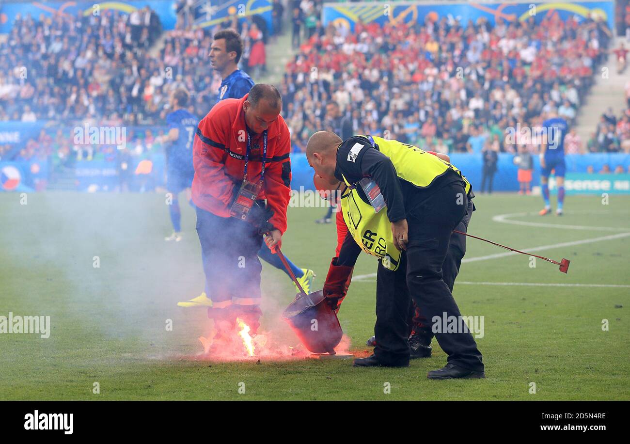 Fire Marshalls extinguish a flare after it was thrown onto the pitch ...