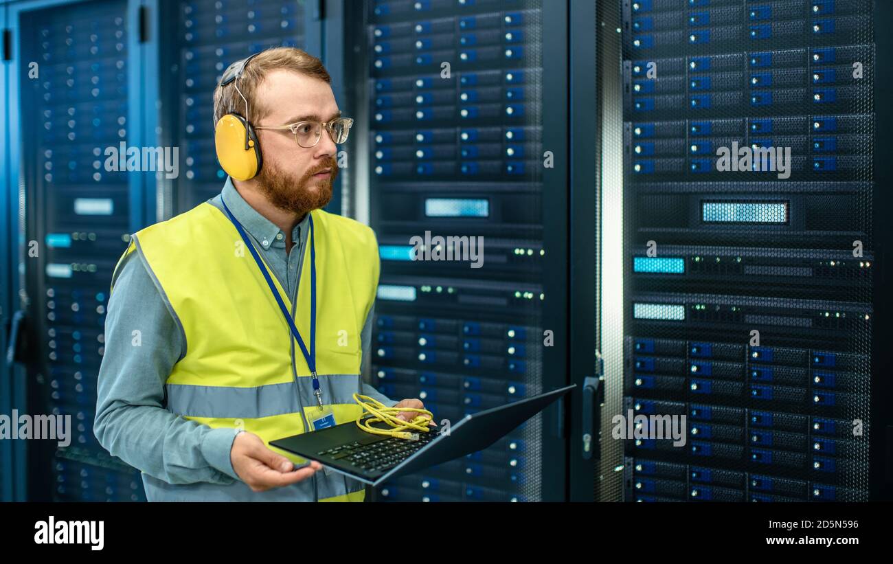 Bearded IT Specialist in Glasses and Headphones, wearing High ...
