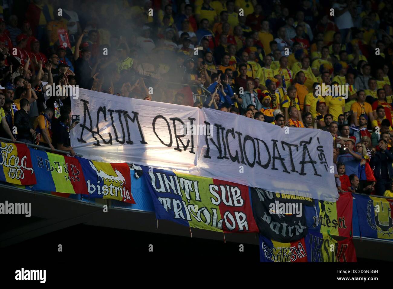 Romania fans set off a flare in the stands Stock Photo - Alamy
