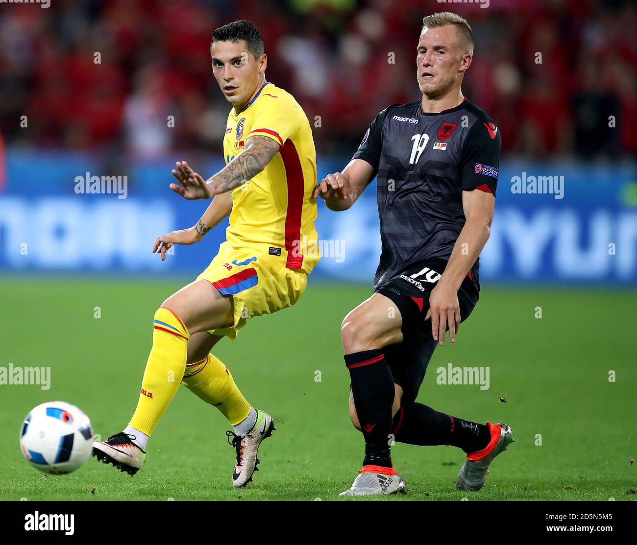 Romania's Nicolae Stanciu (left) and Albania's Bekim Balaj (right ...