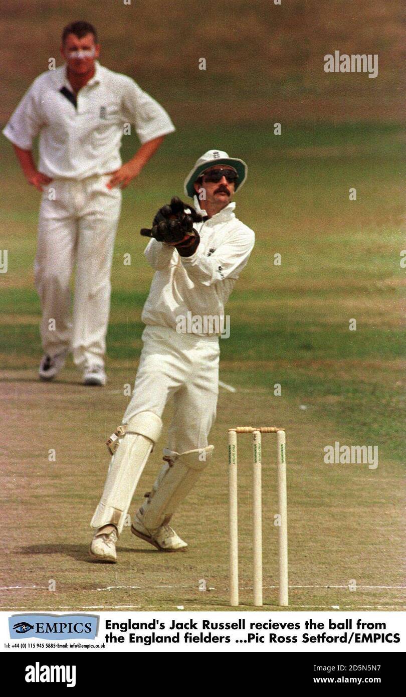 England's Jack Russell receives the ball from the England fielders ...