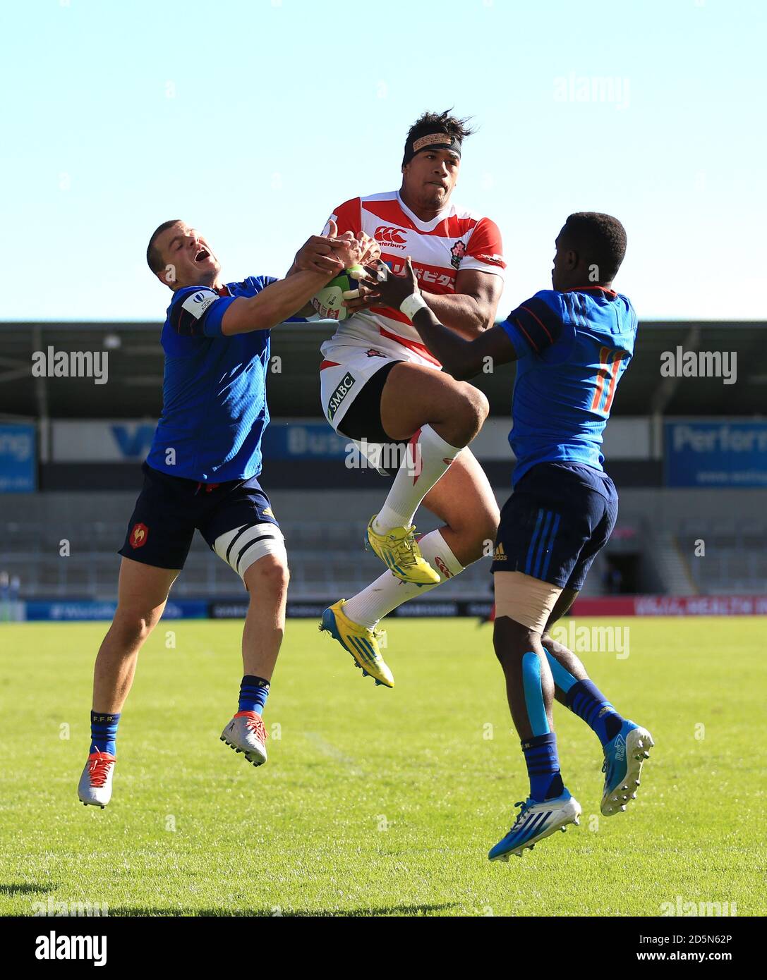 Japan's Ataata Moeakiola (centre) wins the high ball against France's ...