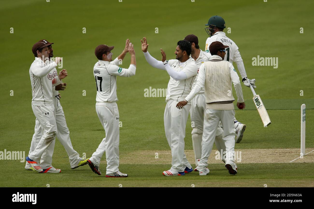 Surrey's Ravi Rampaul (centre right) celebrates bowling out ...