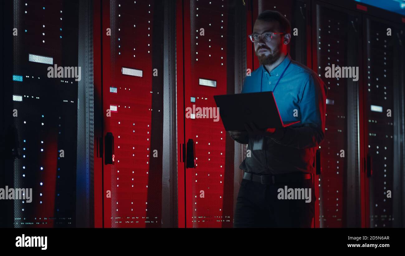 Angry Bearded IT Specialist in Glasses is Walking Through Server Rack ...