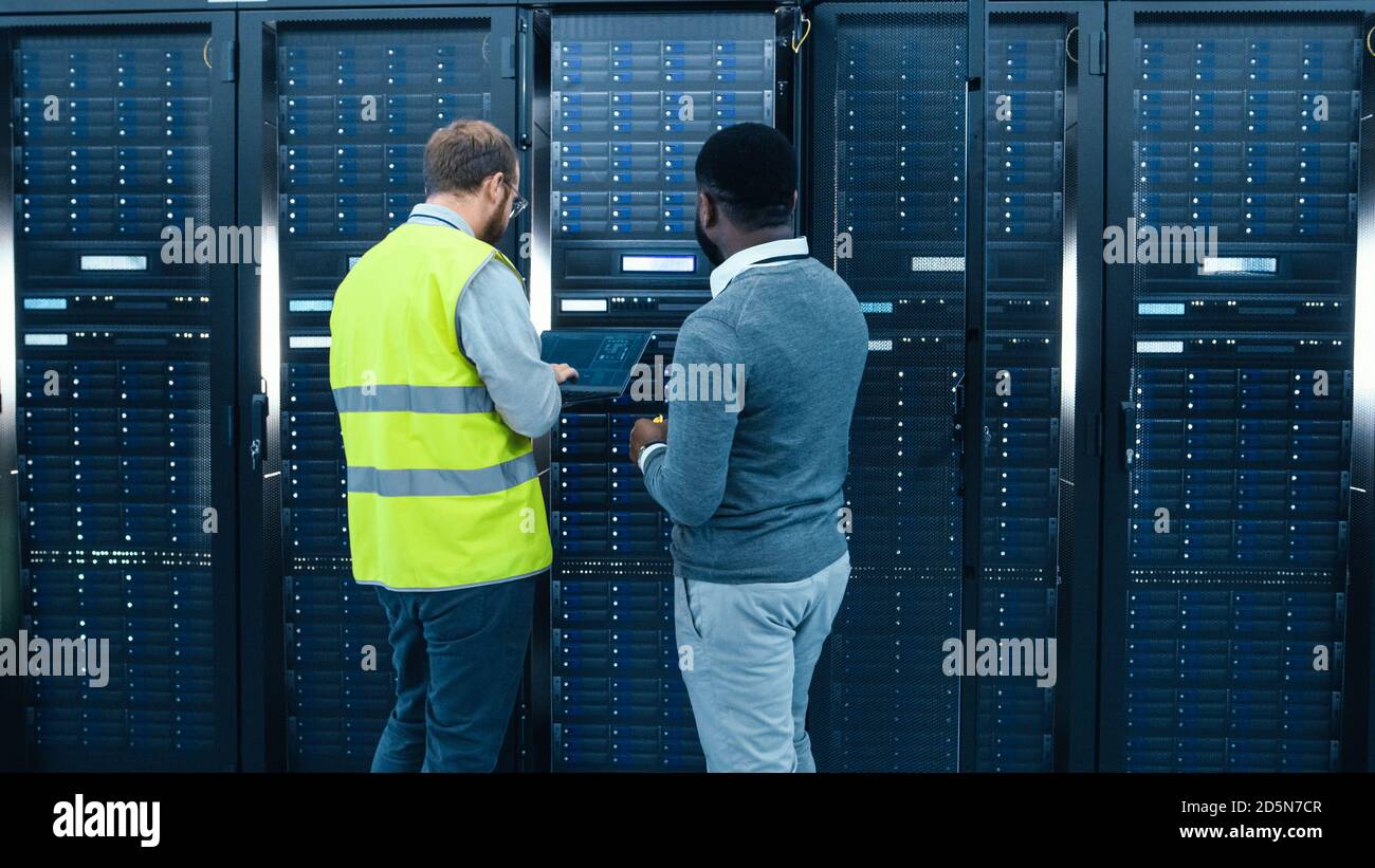 IT Administrator with a Laptop Computer in High Visibility Vest and ...