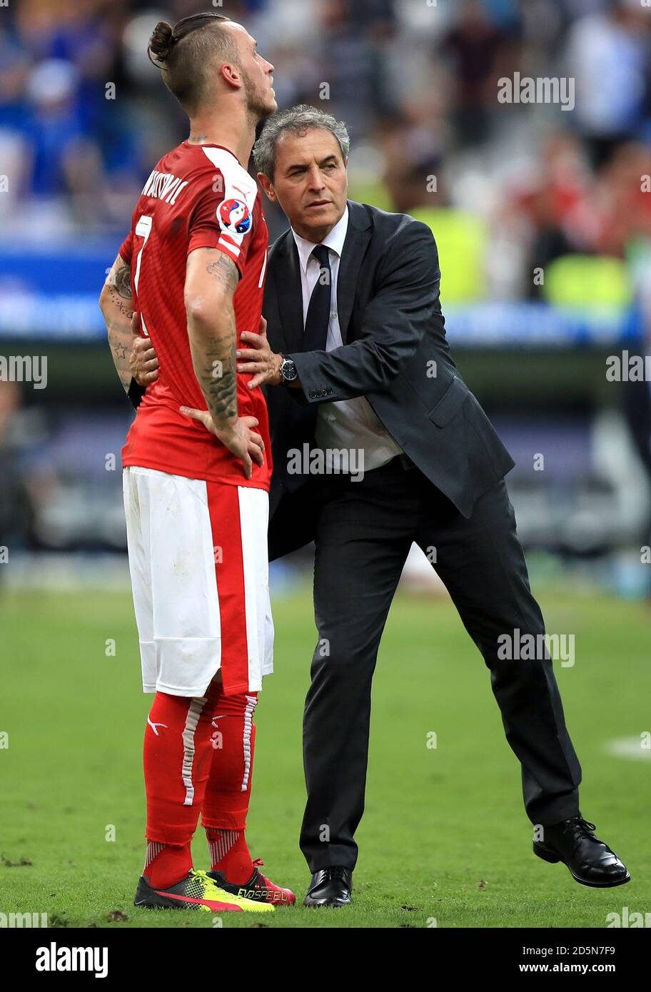 Austria's Marko Arnautovic (left) is consoled by manager Marcel Koller ...