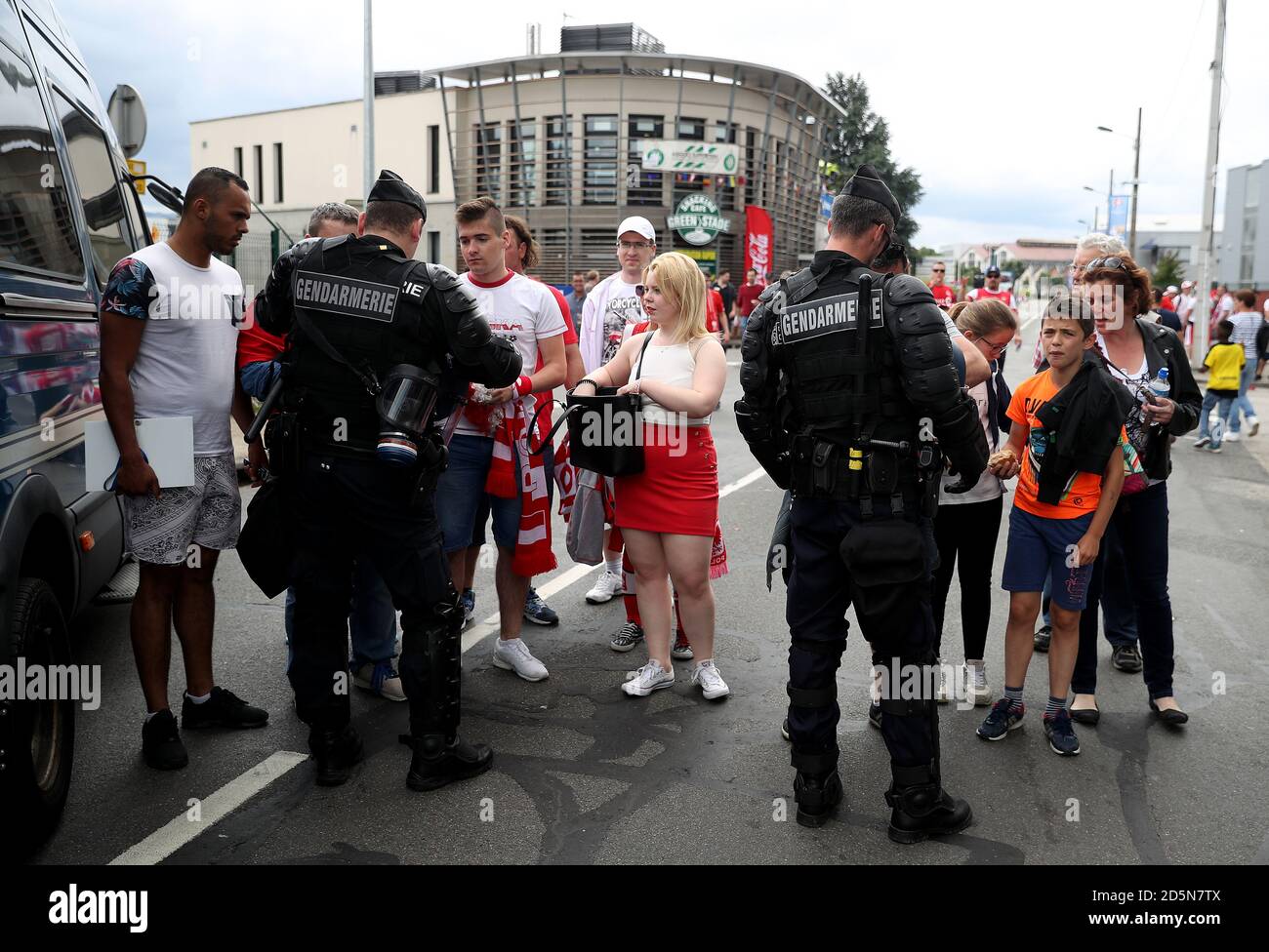 Police officers search bags near the ground Stock Photo - Alamy
