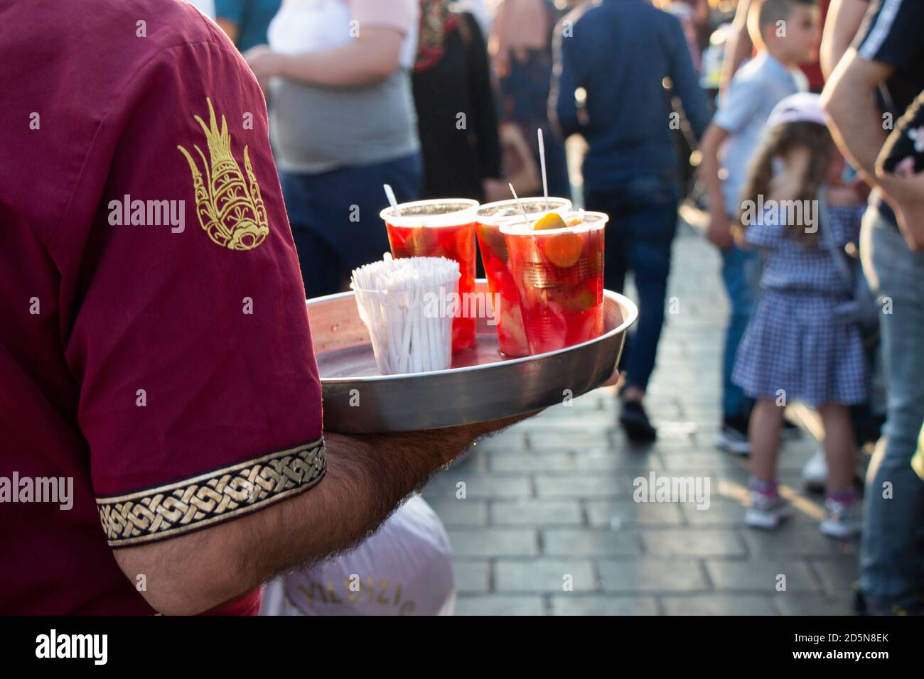 Waiter serving drinks at a festival Stock Photo - Alamy