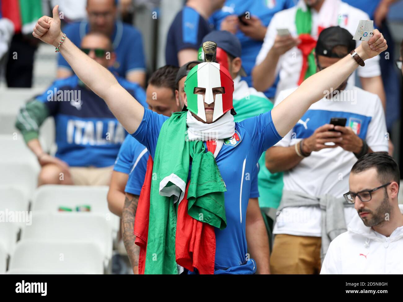 A Italy fan wearing a Roman helmet in the stands Stock Photo - Alamy