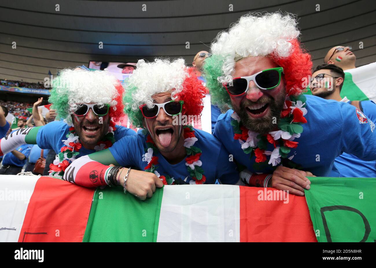 Italy fans wearing bright wigs and sunglasses in the stands Stock Photo ...