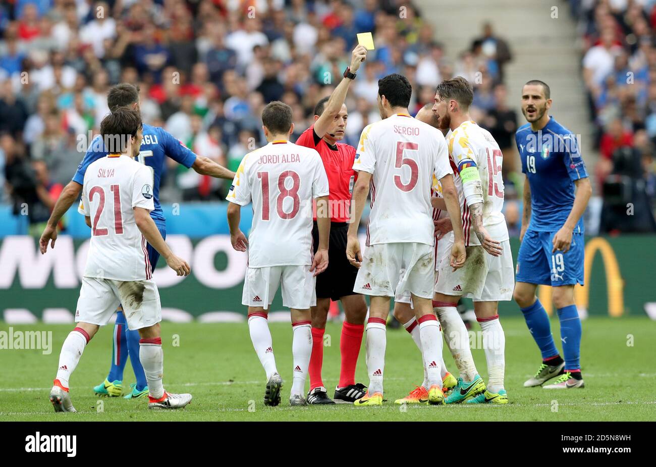 Spain players surround referee Cuneyt Cakir before he brandishes the ...