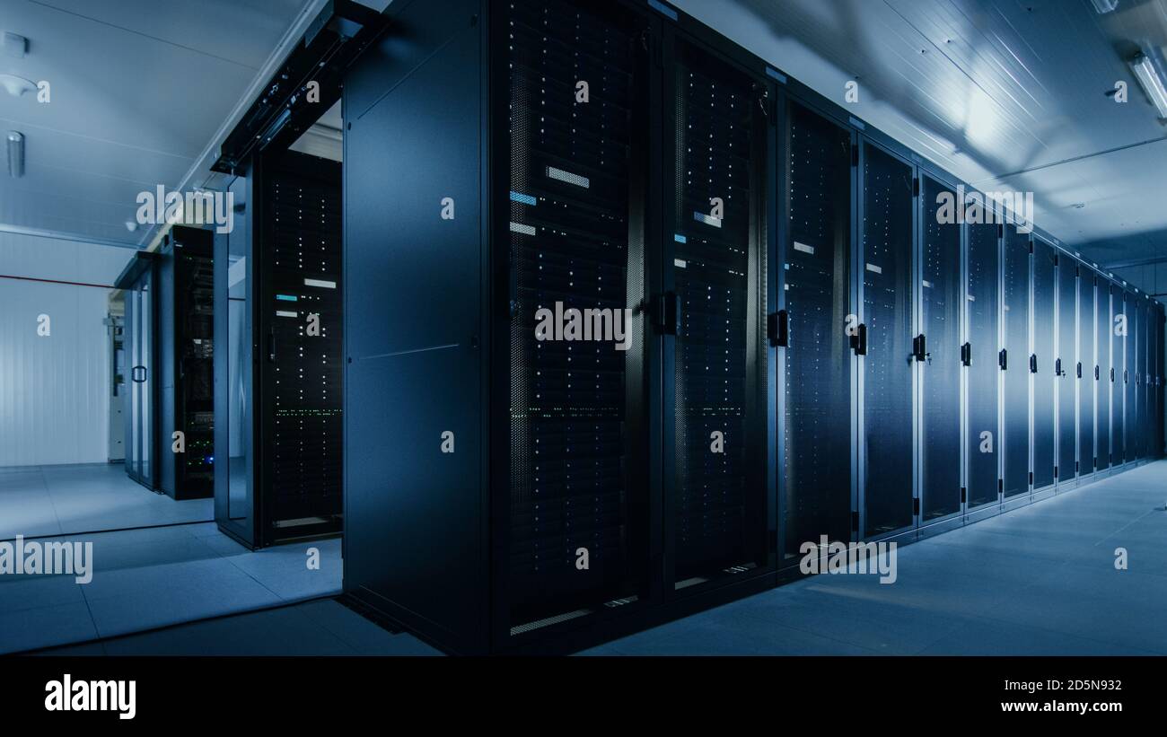 Shot of a Working Data Center With Rows of Rack Servers. Led Lights Blinking and Computers are ...