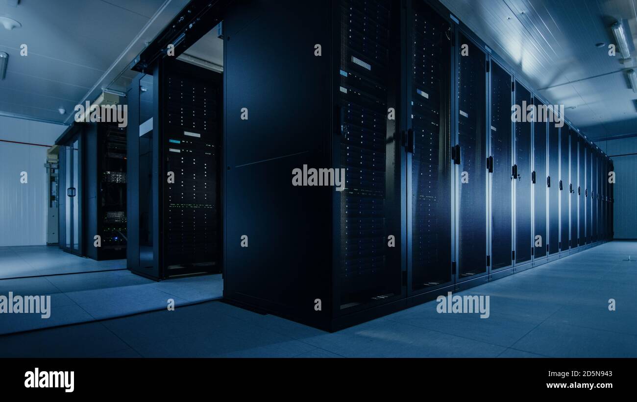 Shot of a Working Data Center With Rows of Rack Servers. Led Lights Blinking and Computers are ...
