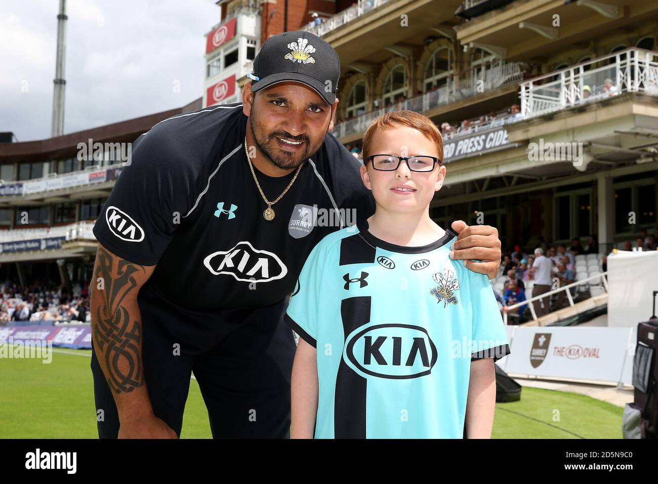 Surrey's Ravi Rampaul with the match day mascot Stock Photo - Alamy