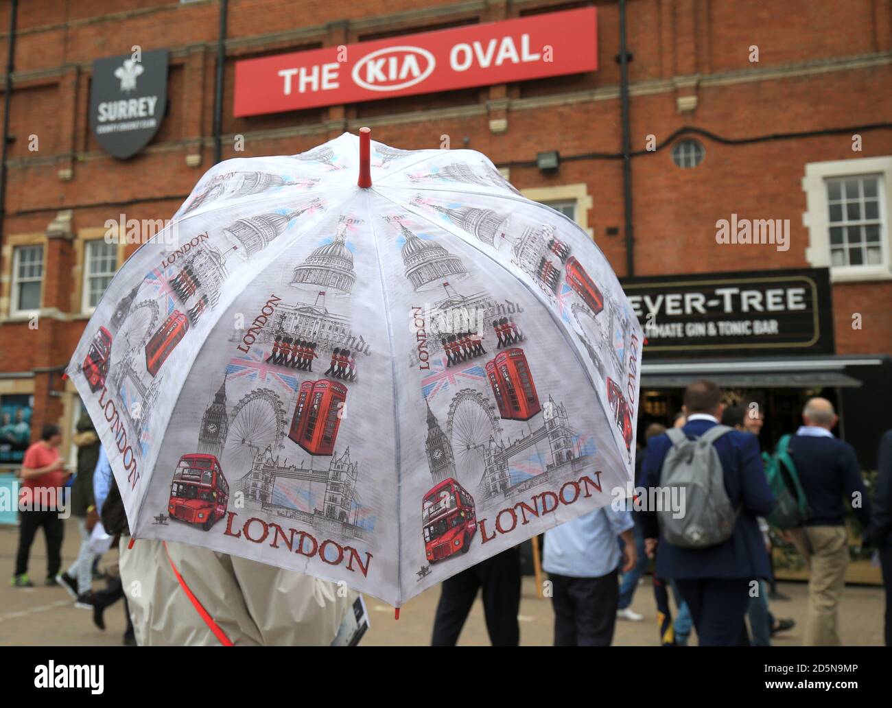A spectator with a London umbrella outside the Kia Oval Stock Photo - Alamy