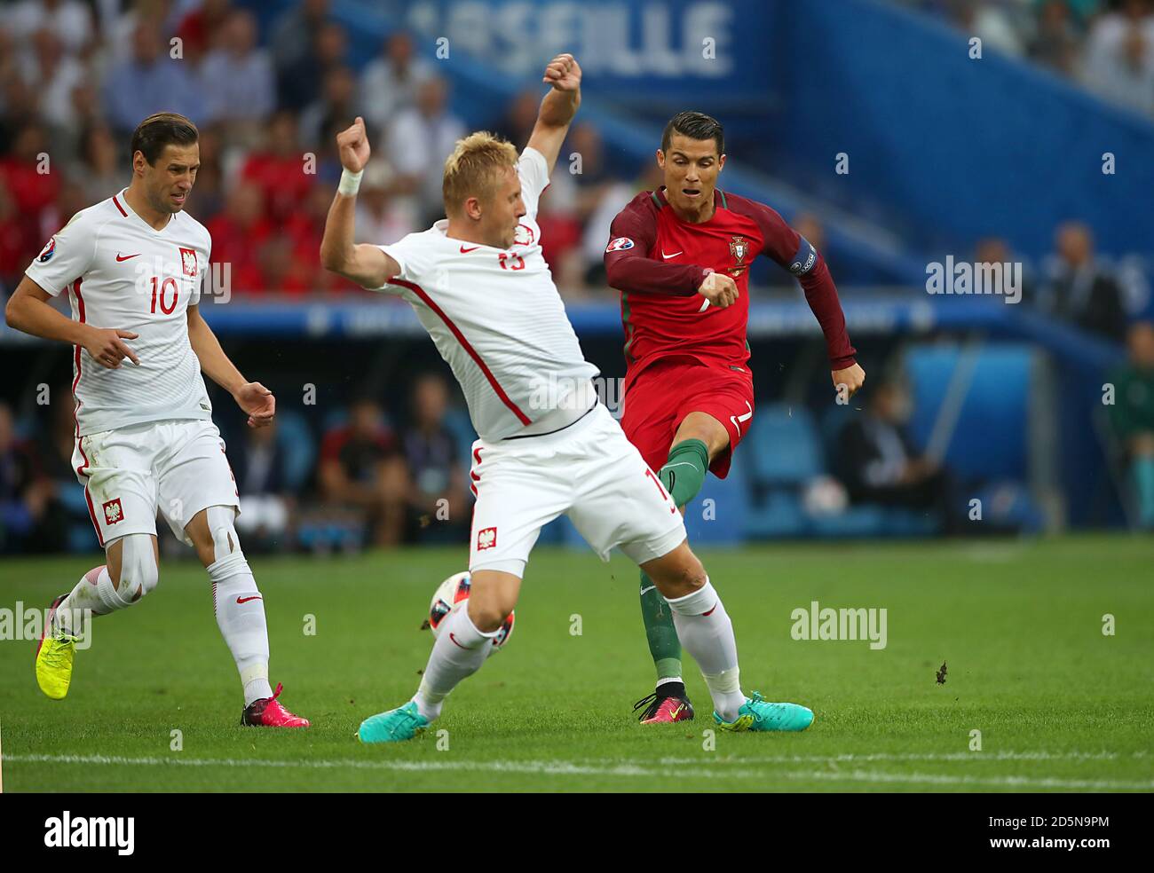 Portugal's Cristiano Ronaldo tries to get a shot past Poland's Kamil ...