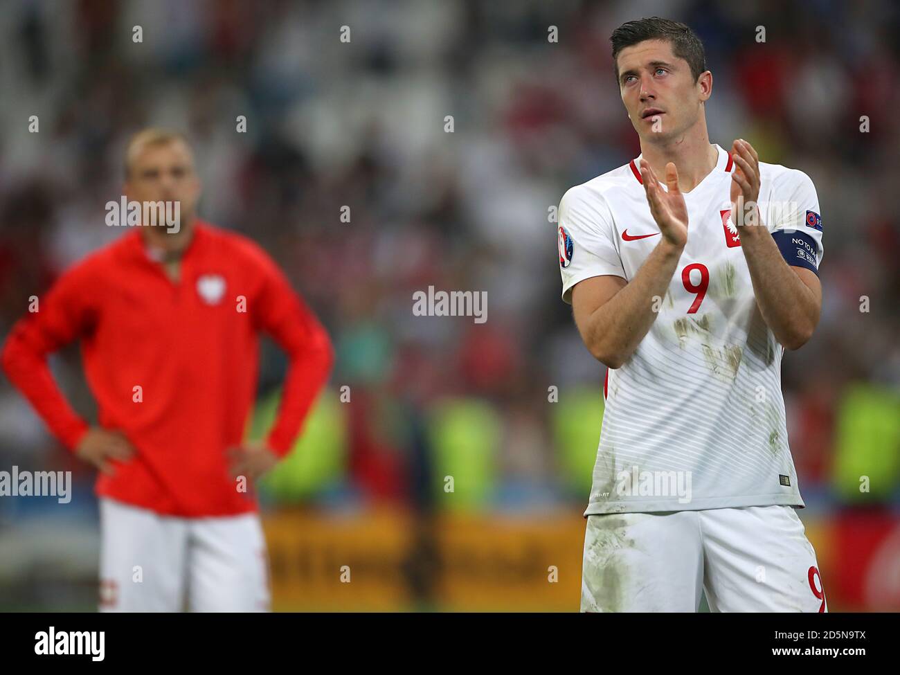 Poland's Robert Lewandowskiapplauds the fans after his side are knocked ...