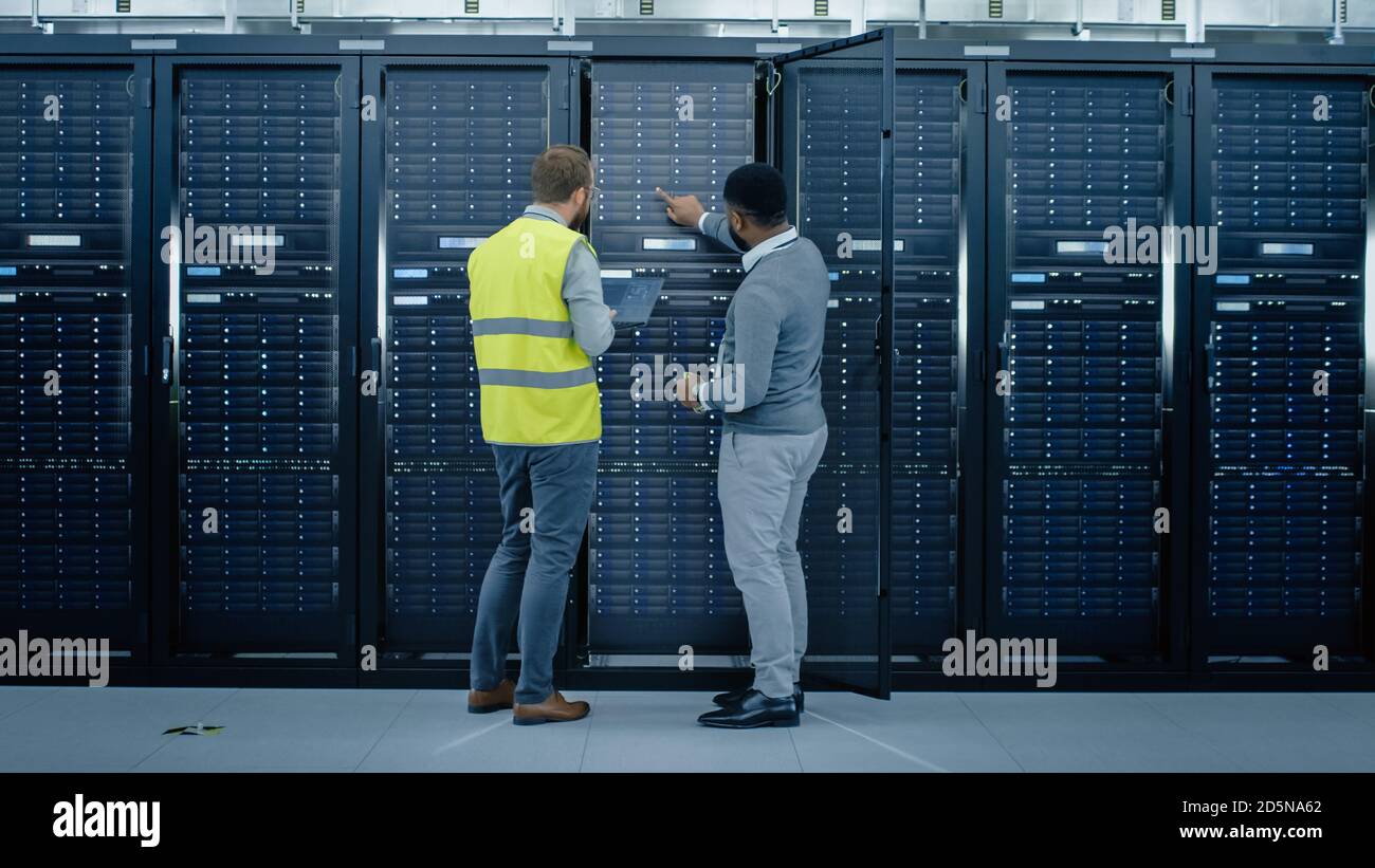 Bearded IT Engineer in Glasses and High Visibility Vest with a Laptop ...