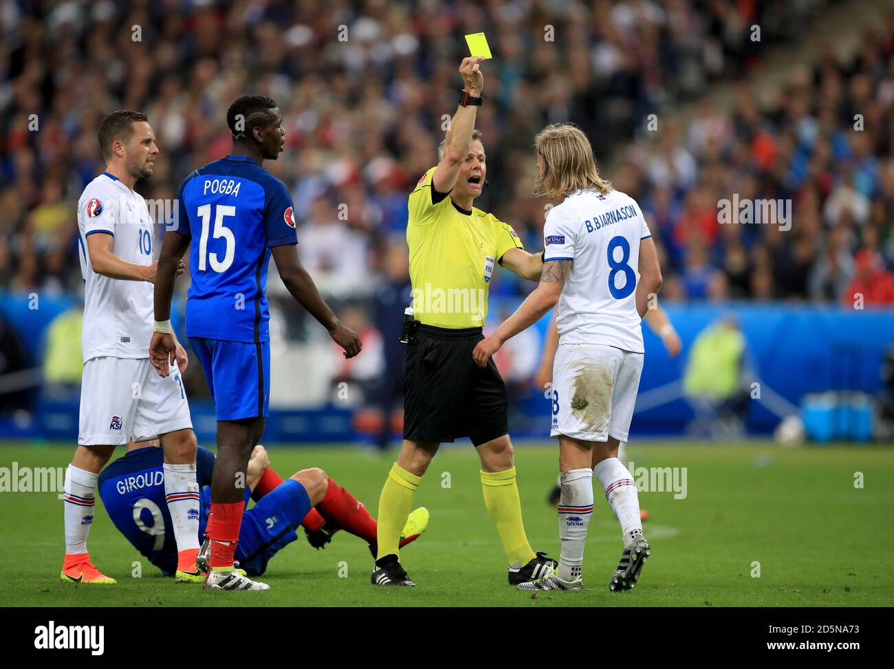 Iceland's Birkir Bjarnason (right) is shown the yellow card by referee ...