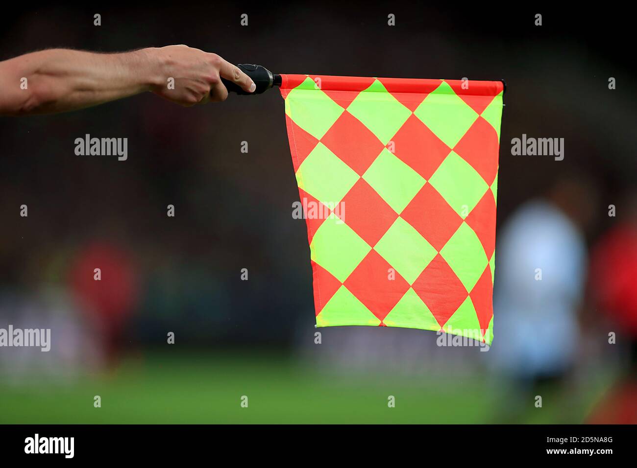 The linesman holds the offside flag Stock Photo - Alamy