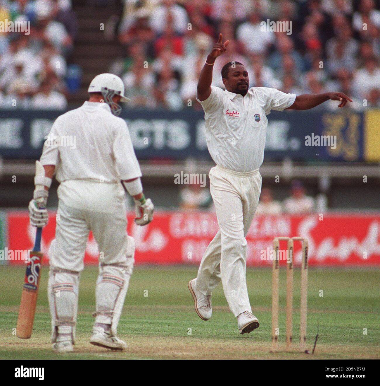 Kenny Benjamin of the West Indies (right) celebrates after dismissing ...