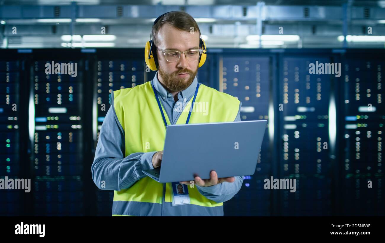 Bearded IT Specialist in Glasses and Headphones, wearing High ...